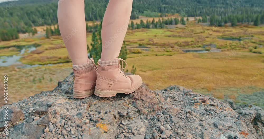 Outdoor adventure and wild nature travel concept. Close up woman legs ...