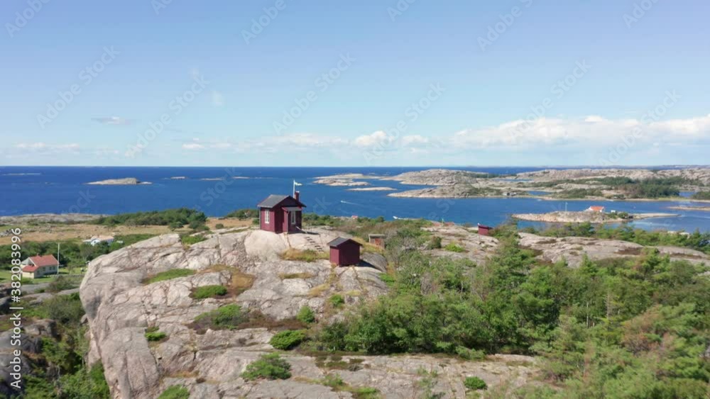 Coastline in Sweden. Aerial drone shot of tiny red summer house on ...