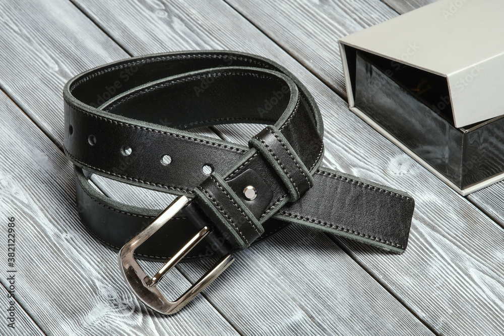 The belt is rolled up, next to a gift box. Template for the design of ...
