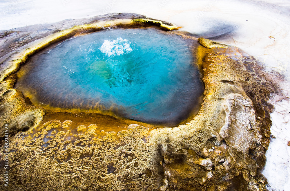 The intense blue bubbling water in the hole of a geyser in Iceland ...