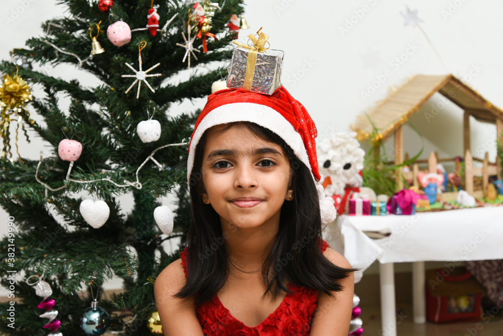 cute little Indian girl celebrating Christmas in India many present ...
