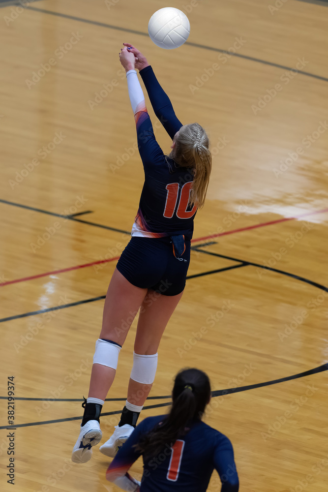 Young girl playing in a competitive volleyball match Stock Photo ...