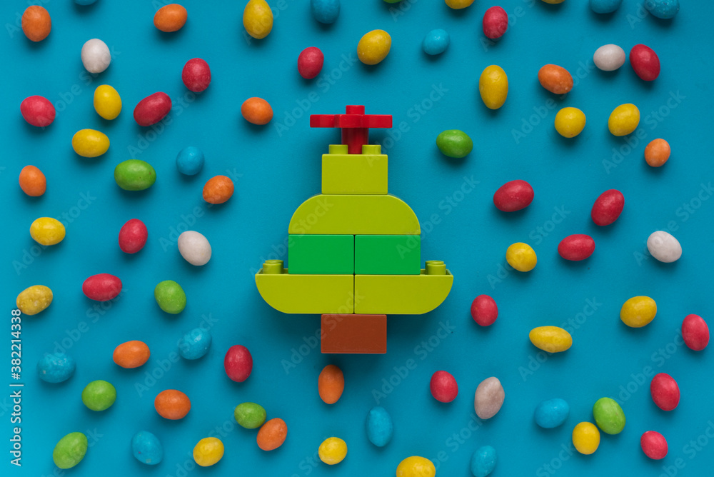 fur-tree from the constructor and multicolored spots on a blue ...