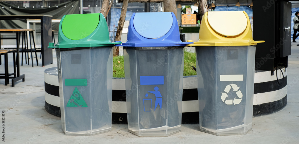 Colorful different types of bins in the park. Symbol for containers and ...