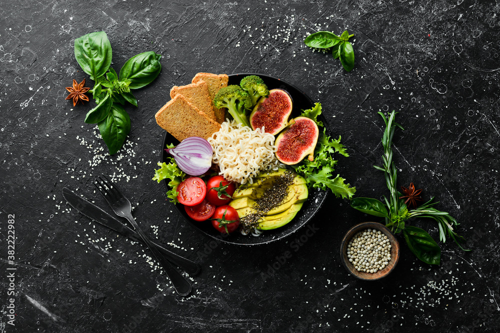 Food. Buddha bowl: noodles with avocado, figs, chia and lettuce in a ...