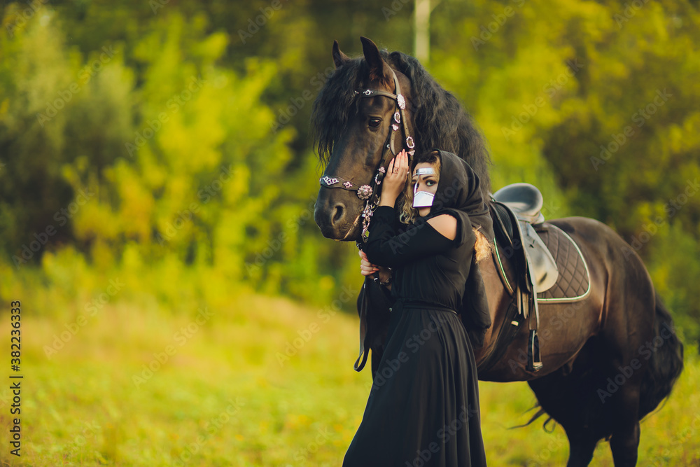 Muslim woman in hijab riding a horse. Stock Photo | Adobe Stock