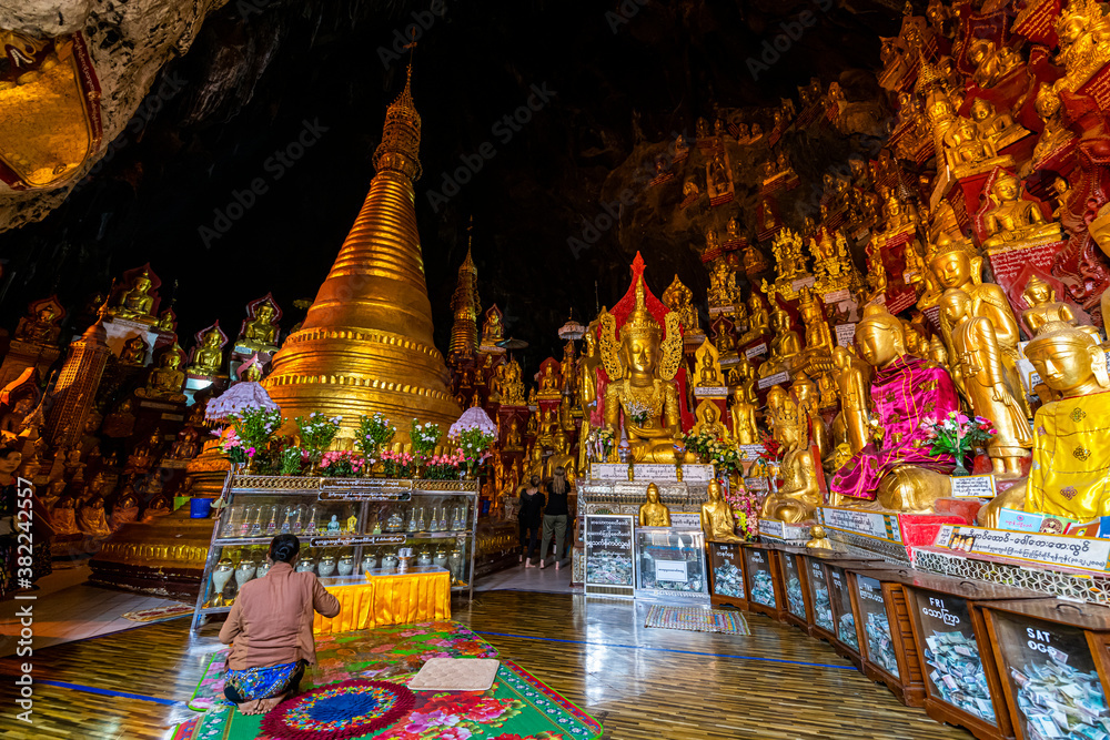 Pilgrims at the gilded Buddha images in the caves at Pindaya, Shan ...