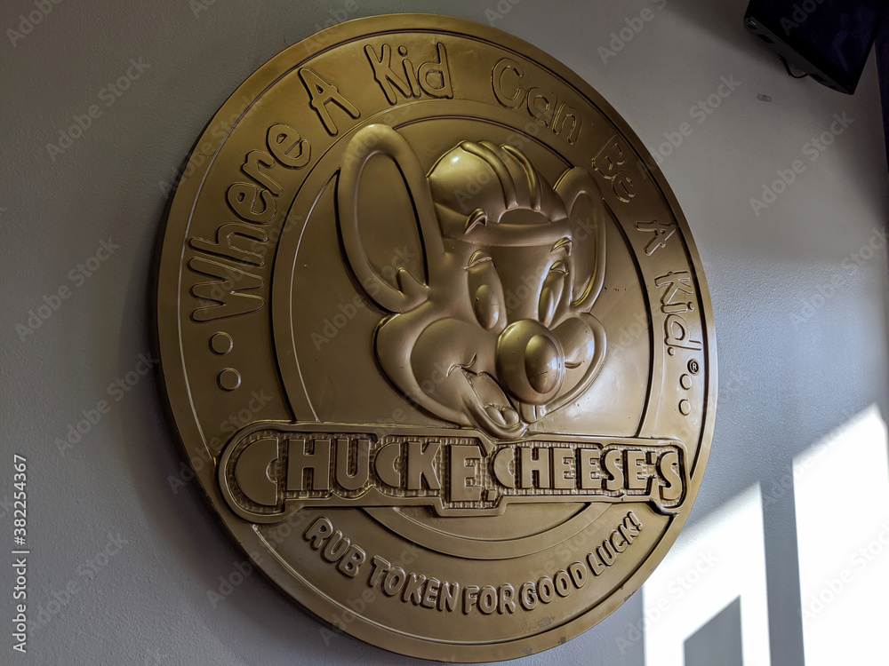 Gold Chuck E. Cheese Emblem on wall Stock Photo | Adobe Stock