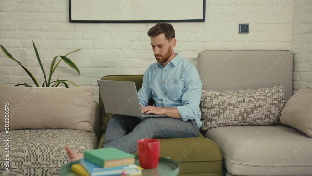 Happy man using laptop typing look at camera waving his hand wants to ...