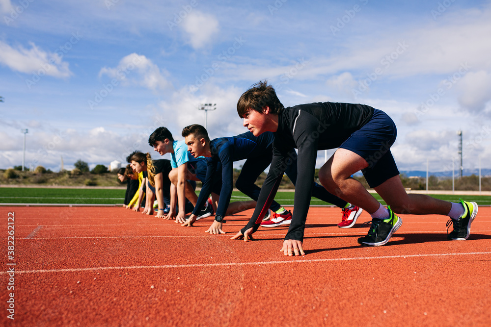 Teen athletes ready to run race Stock Photo | Adobe Stock