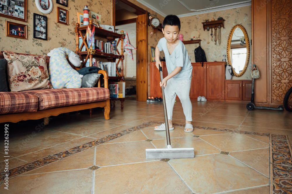 Boy doing chores Stock Photo | Adobe Stock