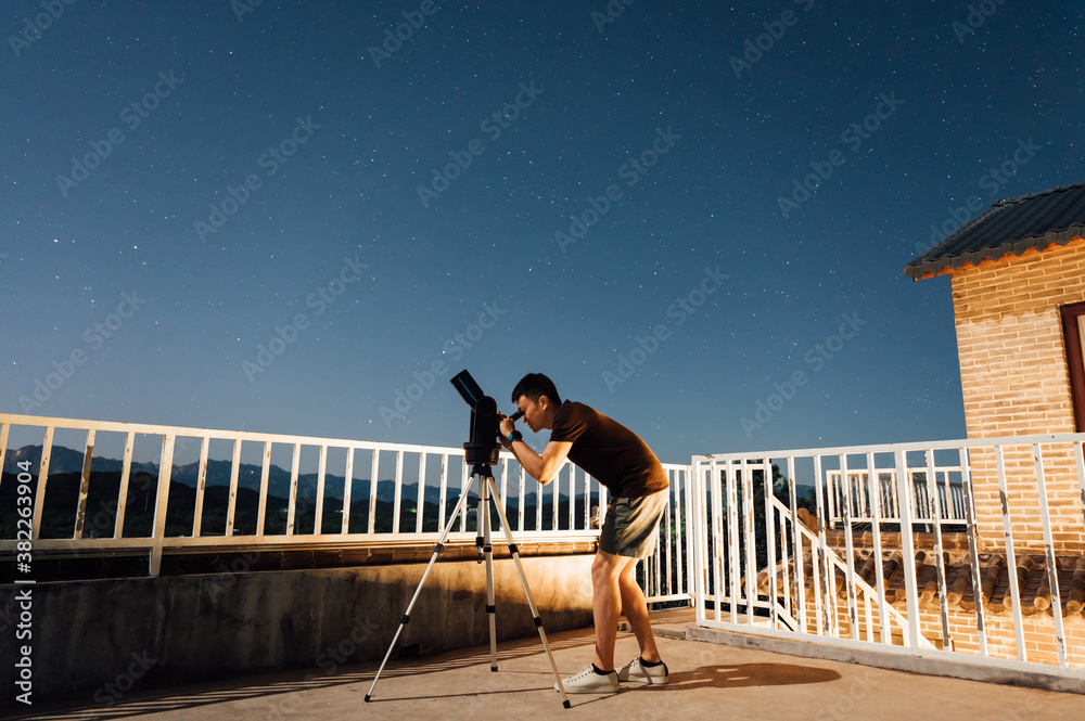Men looking at stars with telescope Stock Photo | Adobe Stock