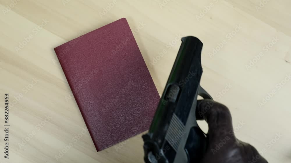 A hand in black glove putting nternational passport of the Russian ...