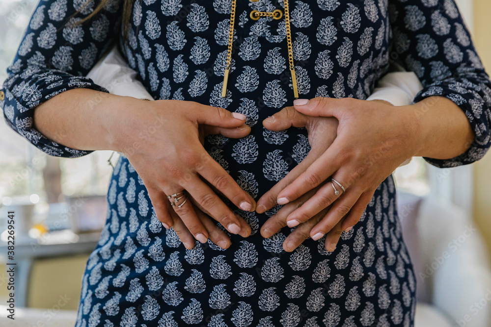 Husband and Wife holding belly of Pregnant Woman Stock Photo | Adobe Stock