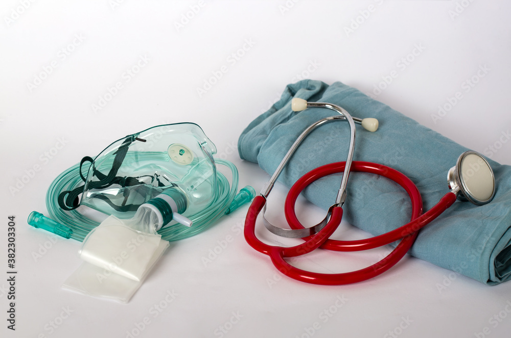 Medical stethoscope lying on a blue doctor's form and medical equipment ...