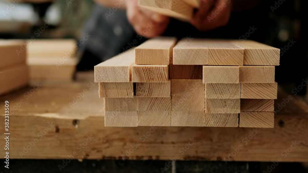 Heap of solid wood at furniture factory. Timber material processing and ...