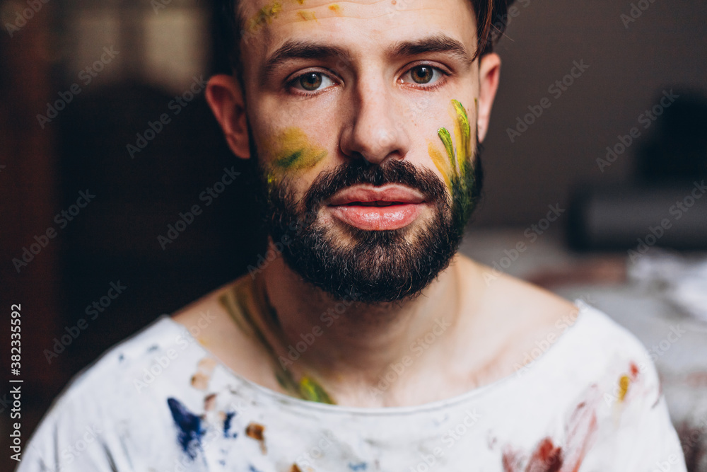 Young creative man who is fond of drawing poses for a photo in his ...