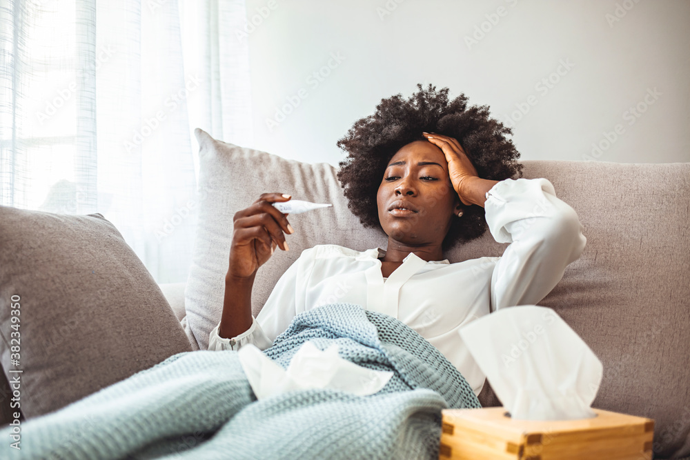 African-american sick woman with runny nose, sitting in bed, free space ...