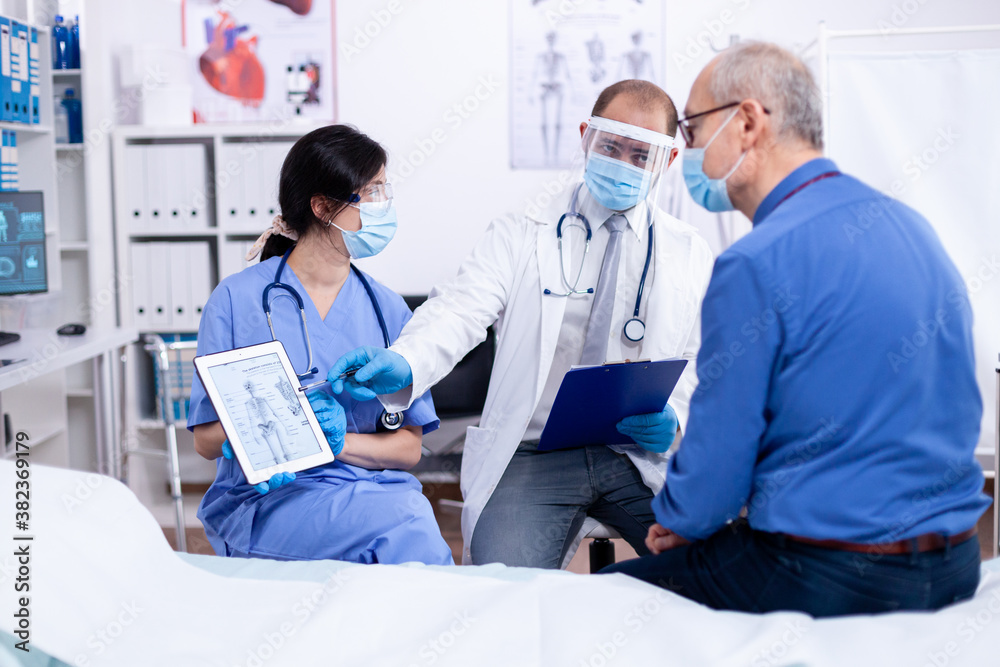 Patient looking at radiography of his skeleton during consultation with ...