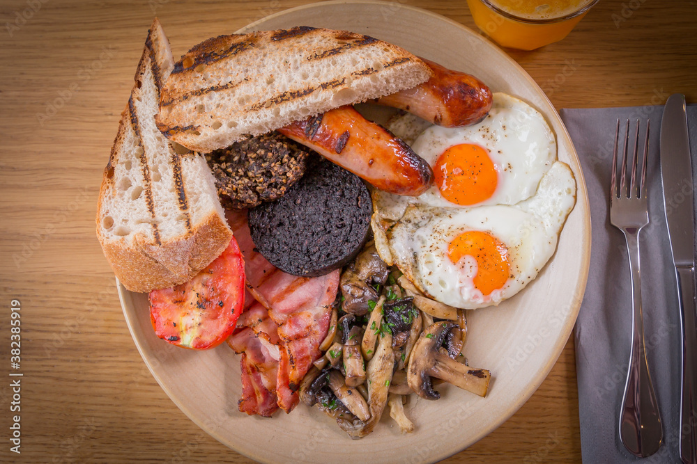 Full Scottish breakfast containing tomato, black pudding, haggis ...
