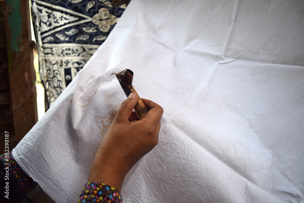 Women's hands do batik techniques on cloth. The batik technique in ...