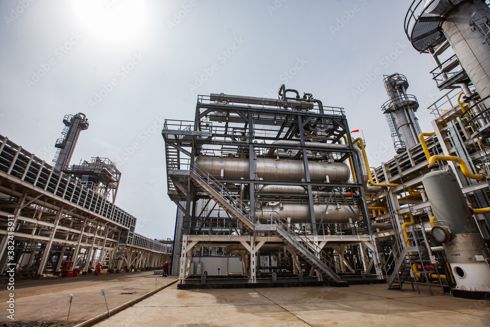 Oil refinery and gas processing plant. Grey metal distillation tower ...