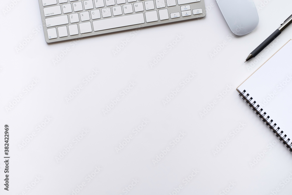 Top view above of White office desk table with keyboard, notebook and ...