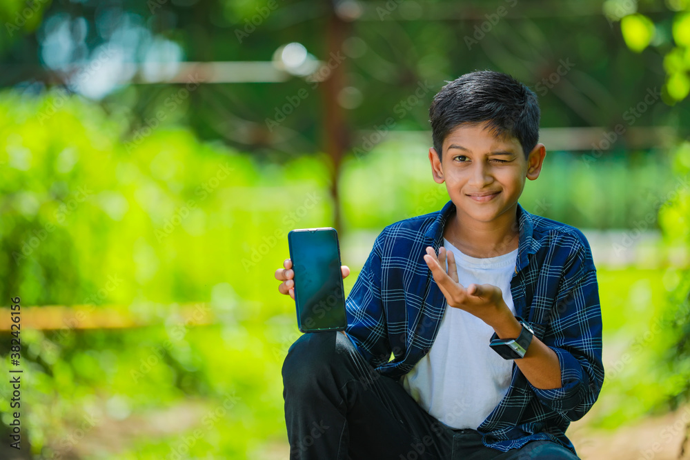childhood, technology and people concept - indian cute school boy ...