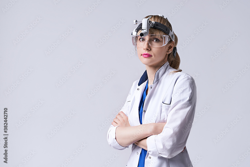 Confident ENT doctor wearing surgical headlight head light and ...