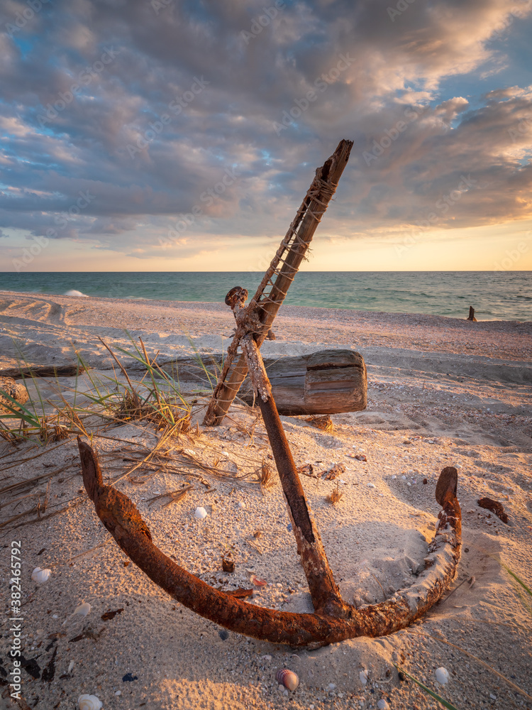 alone old anchor on the beach in sunset time under clouds Stock Photo ...