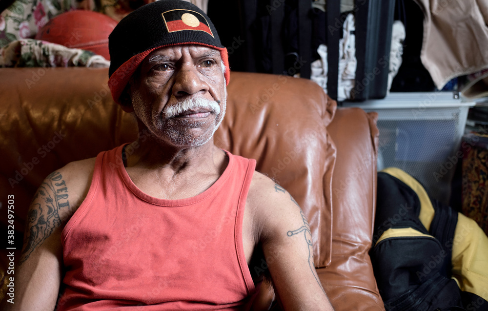 Aboriginal Man Seated Indoors Wearing a Singlet Stock Photo | Adobe Stock