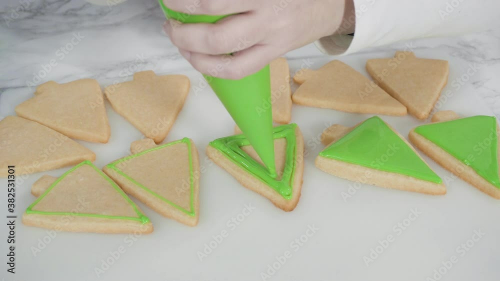 Stp by step. Icing Christmas tree-shaped sugar cookies with green royal ...