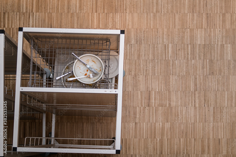 Empty plates in a tray trolley in a cafeteria Stock Photo | Adobe Stock