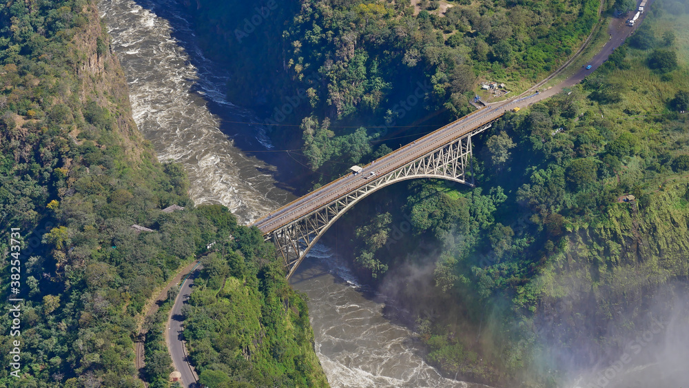 Aerial view of famous Victoria Falls Bridge, marking the border of ...