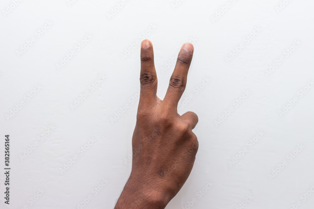 Boy hand showing number two gesture symbol isolated on white background ...