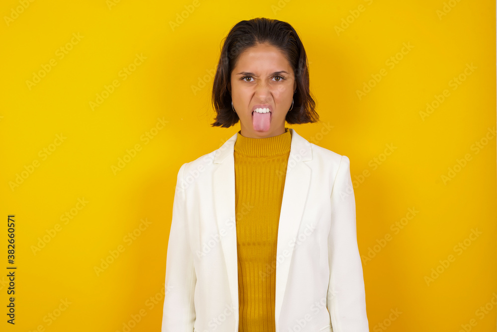 Body language. Disgusted stressed out pretty girl posing against gray ...