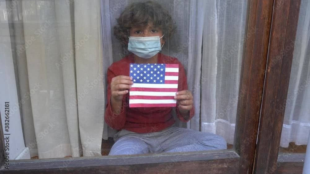 white caucasian American boy 6 years old in quarantine home with mask ...