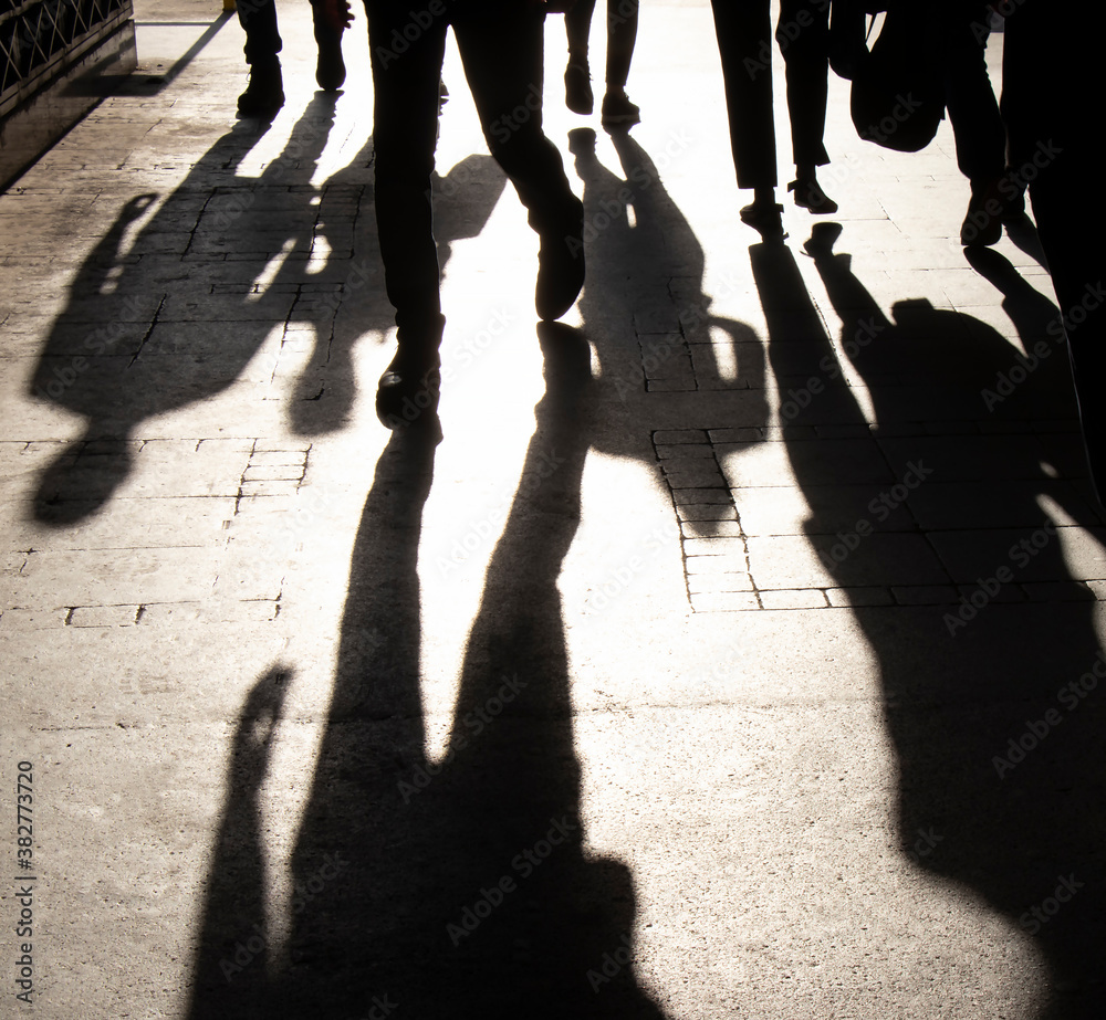Blurry shadow silhouette of people walking on pedestrian street in ...
