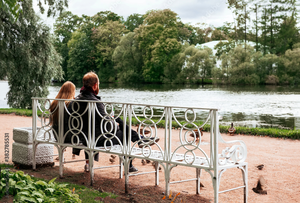 2 People Sitting On A Bench