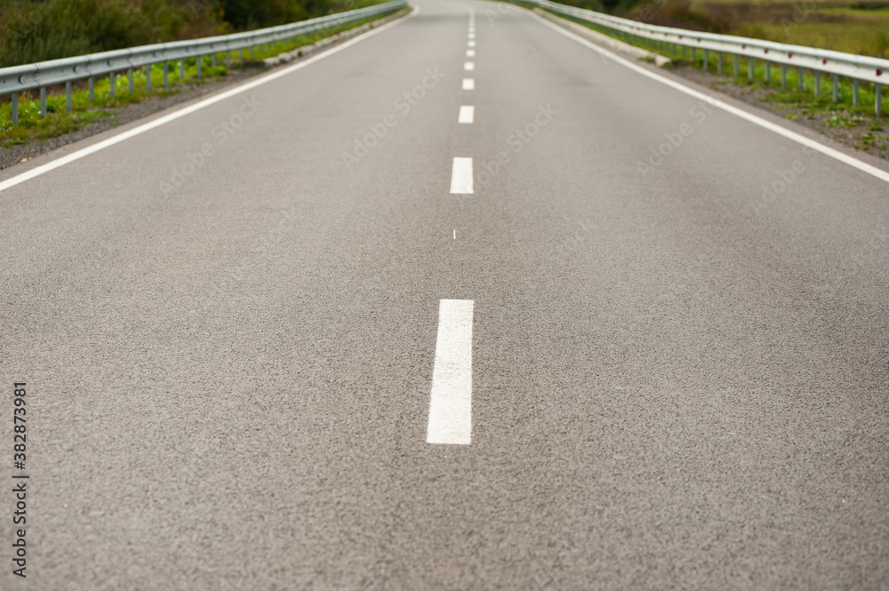 Smooth asphalt road with bumpers and markings Stock Photo | Adobe Stock