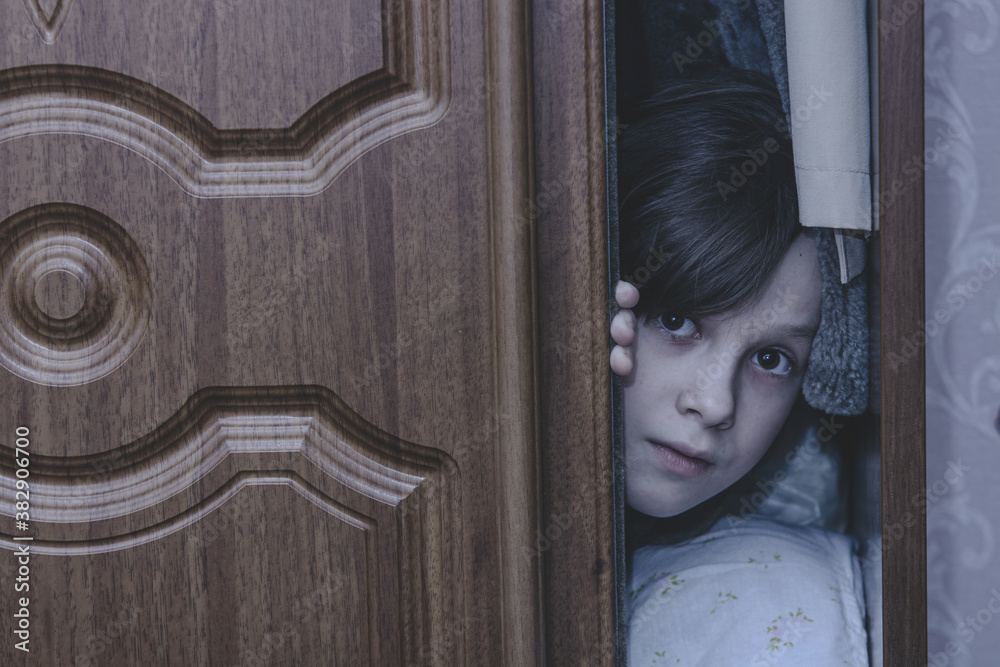 Child scared of nightmare and hiding in closet. Ghost of little girl ...