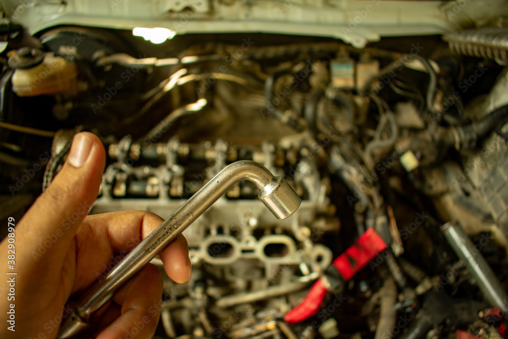 mechanic hand with a tool of car repair called wrench and service car ...