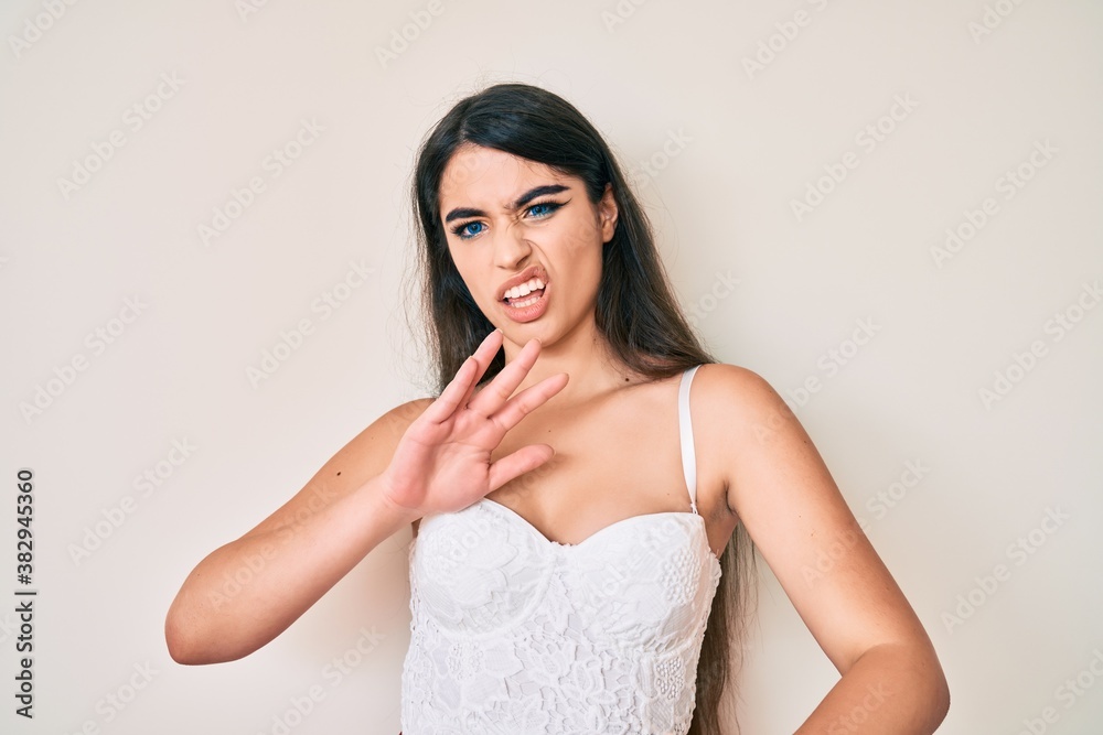 Brunette teenager girl posing elegant disgusted expression, displeased ...