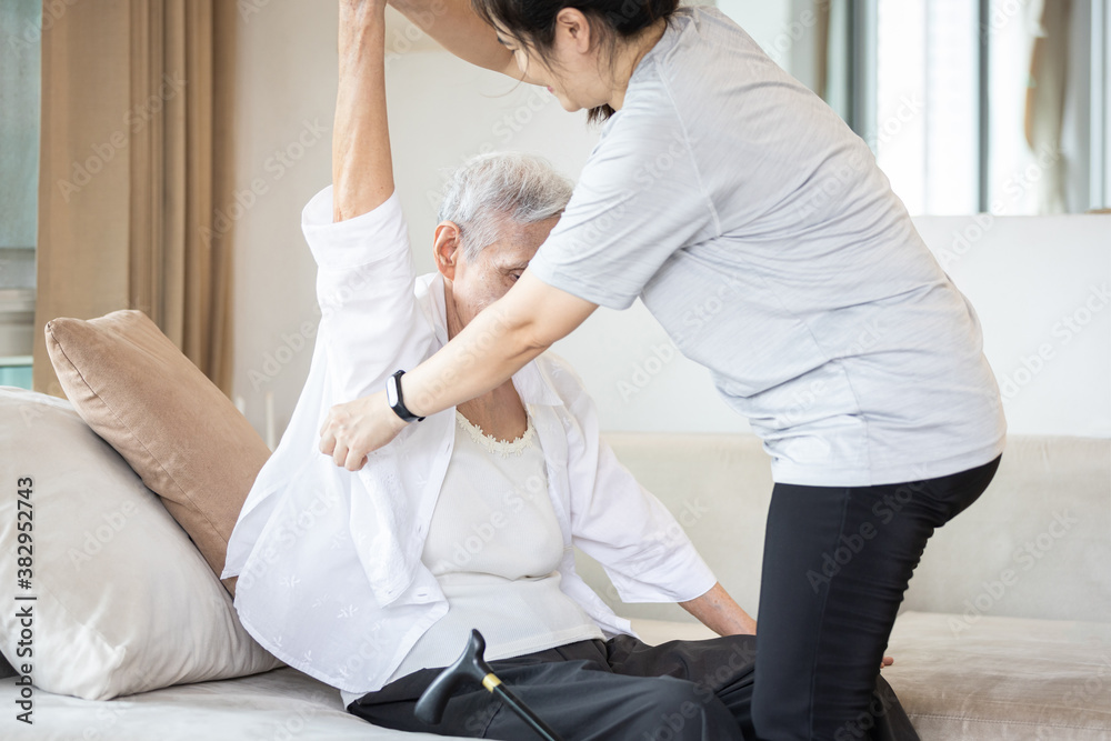 Assisting in dressing,asian female caregiver taking care of helping ...