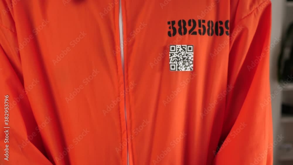 Prisonere inmate wearing an orange jail suit with a QR code for ...