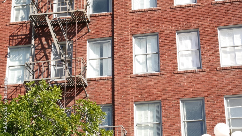 Fire escape ladder outside residential brick building in San Diego city ...