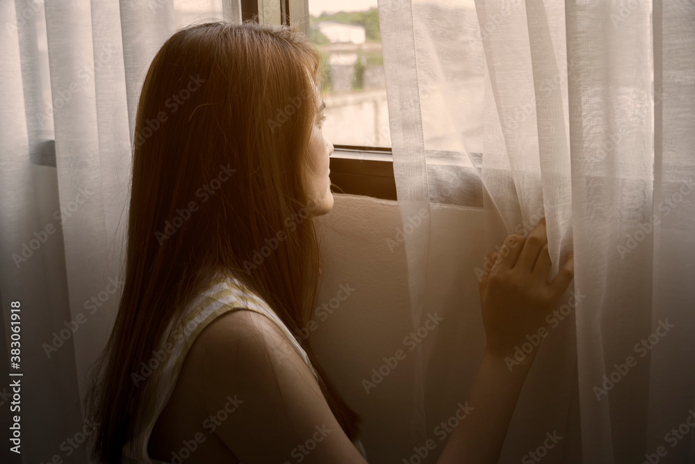 Thoughtful women standing with looking at window, sad depressed ...