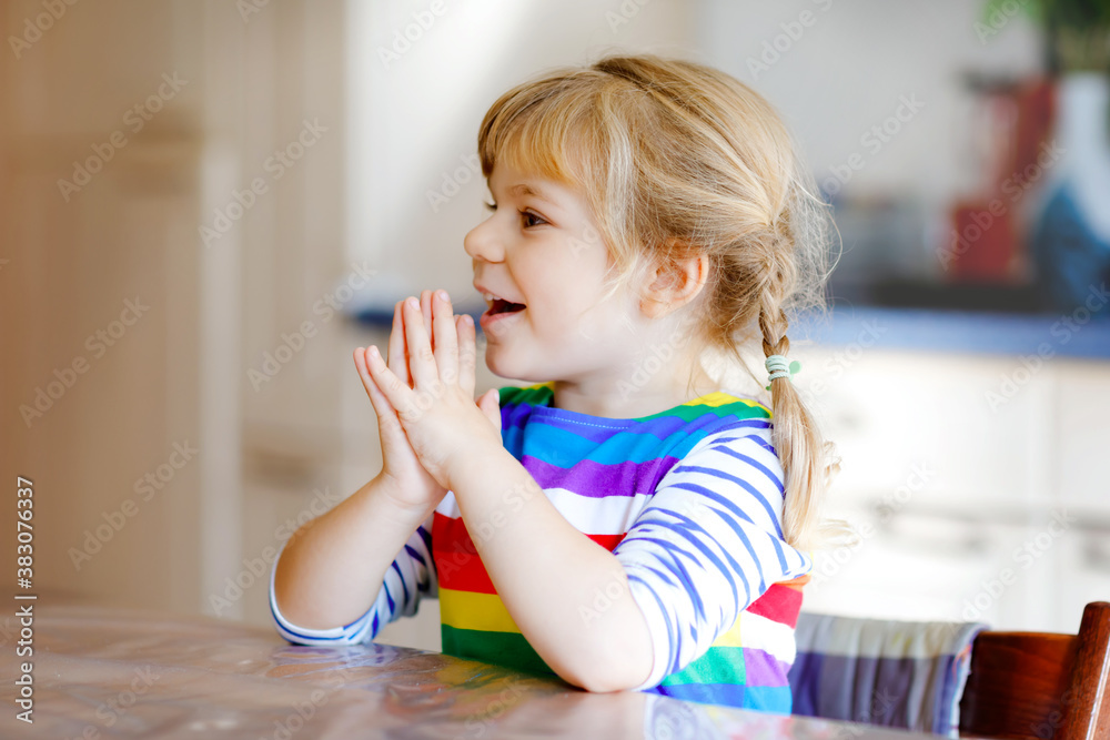 Cute toddler girl praying to God at home. Child using hands for pray ...