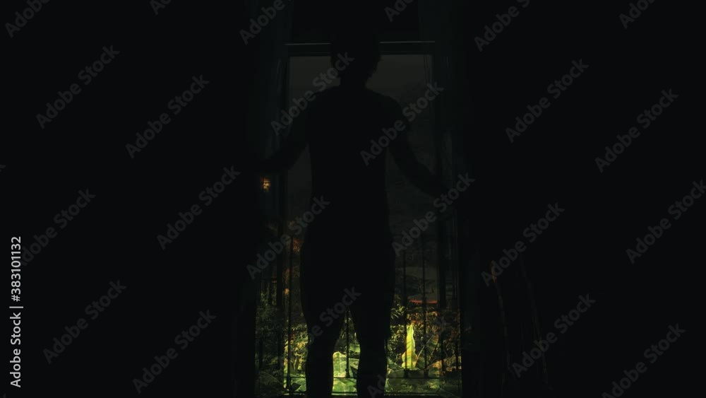 Man Opens Window Watching Forest Fire. Silhouette of a man opening the ...