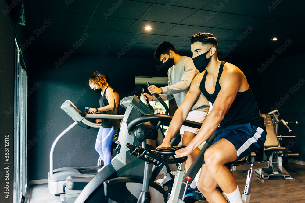 group of young people wearing face masks working out at the gym Stock ...